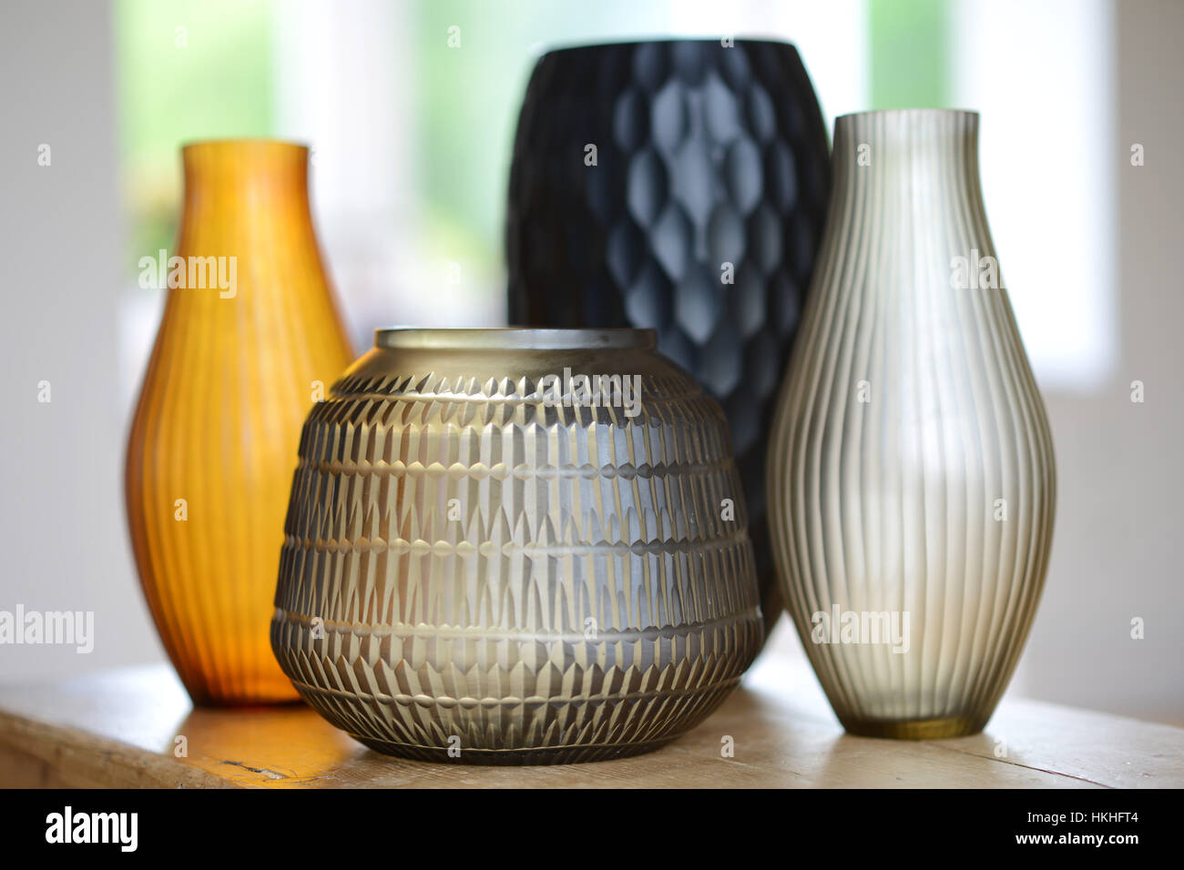 Group of four decorative cut glass vases in a room Stock Photo - Alamy