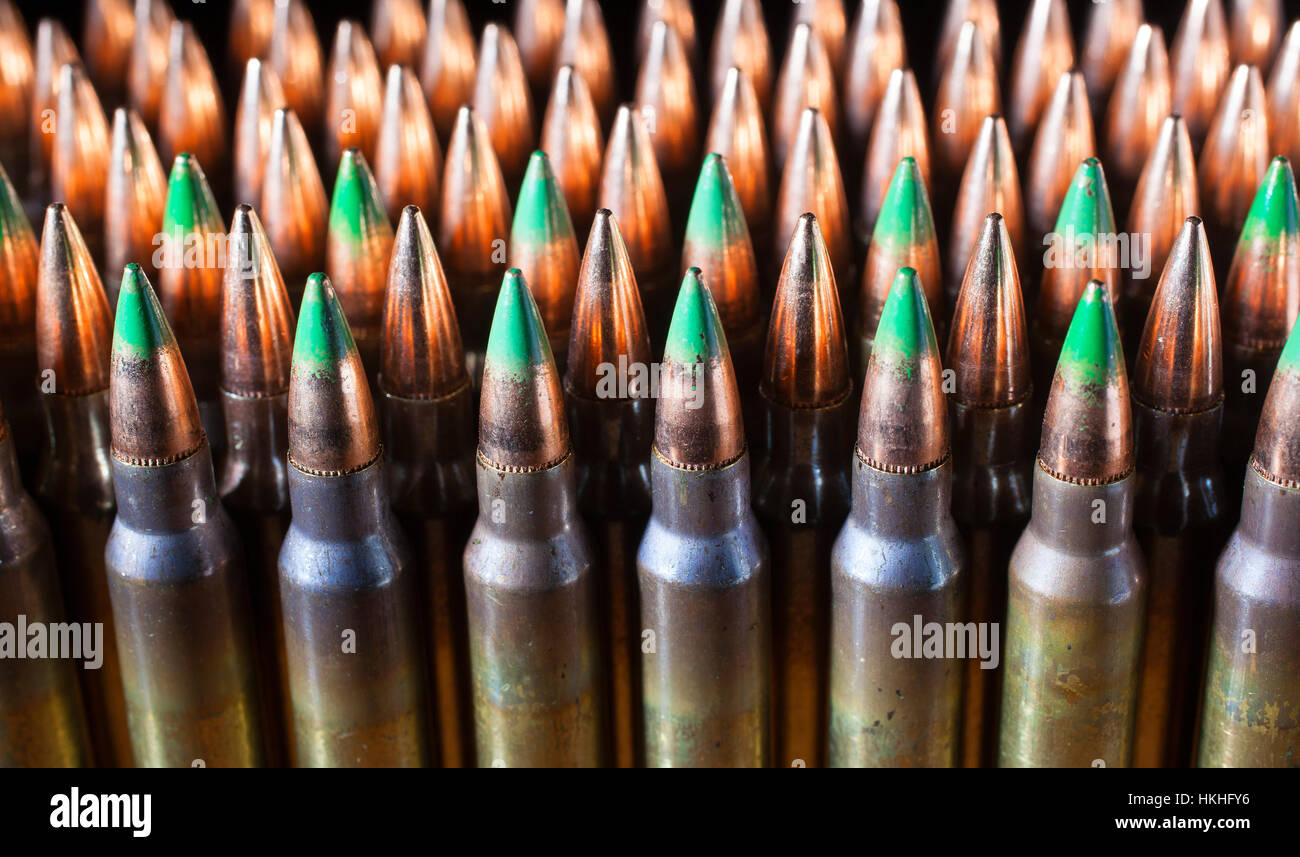 Big group of rifle cartridges and some have bullets with green tips ...
