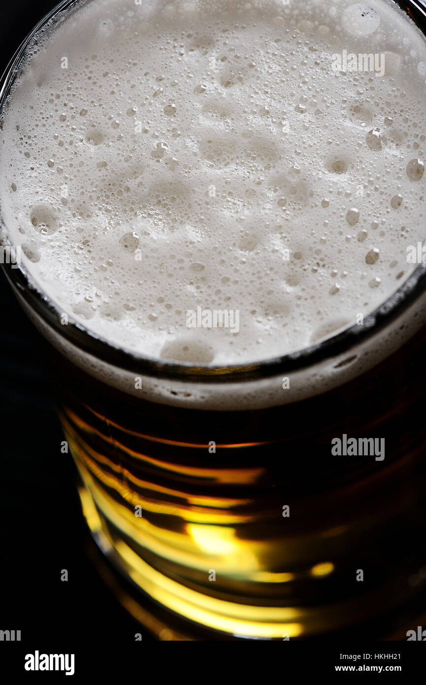 close up of bubbles on beer foam in big glass on black background Stock ...