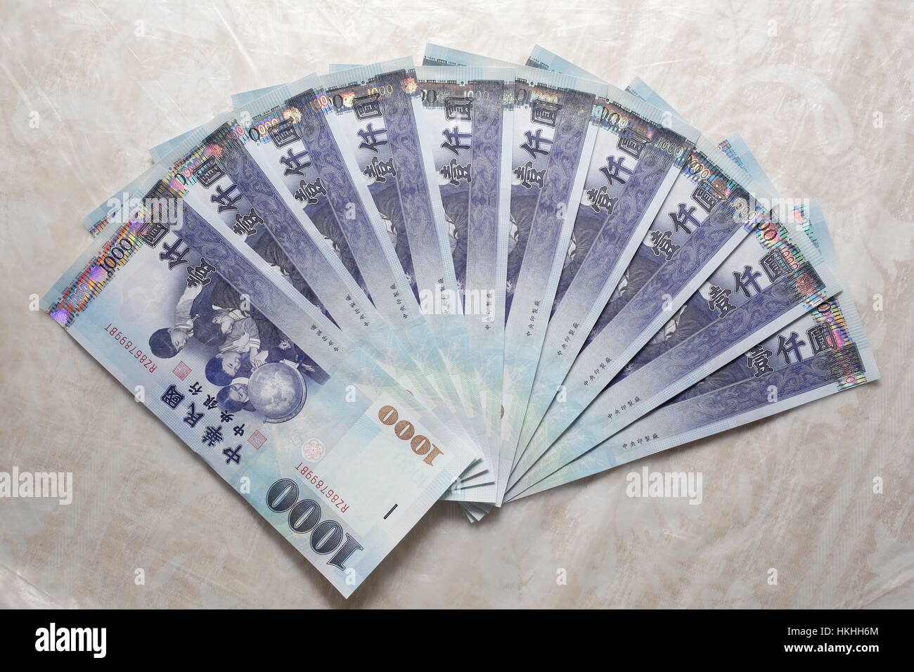 Currency of 10000 new Taiwan dollars display on table.Currency of 10000 ...