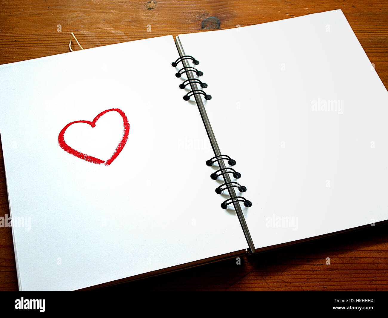 open book with red heart drawing on wooden background Stock Photo - Alamy