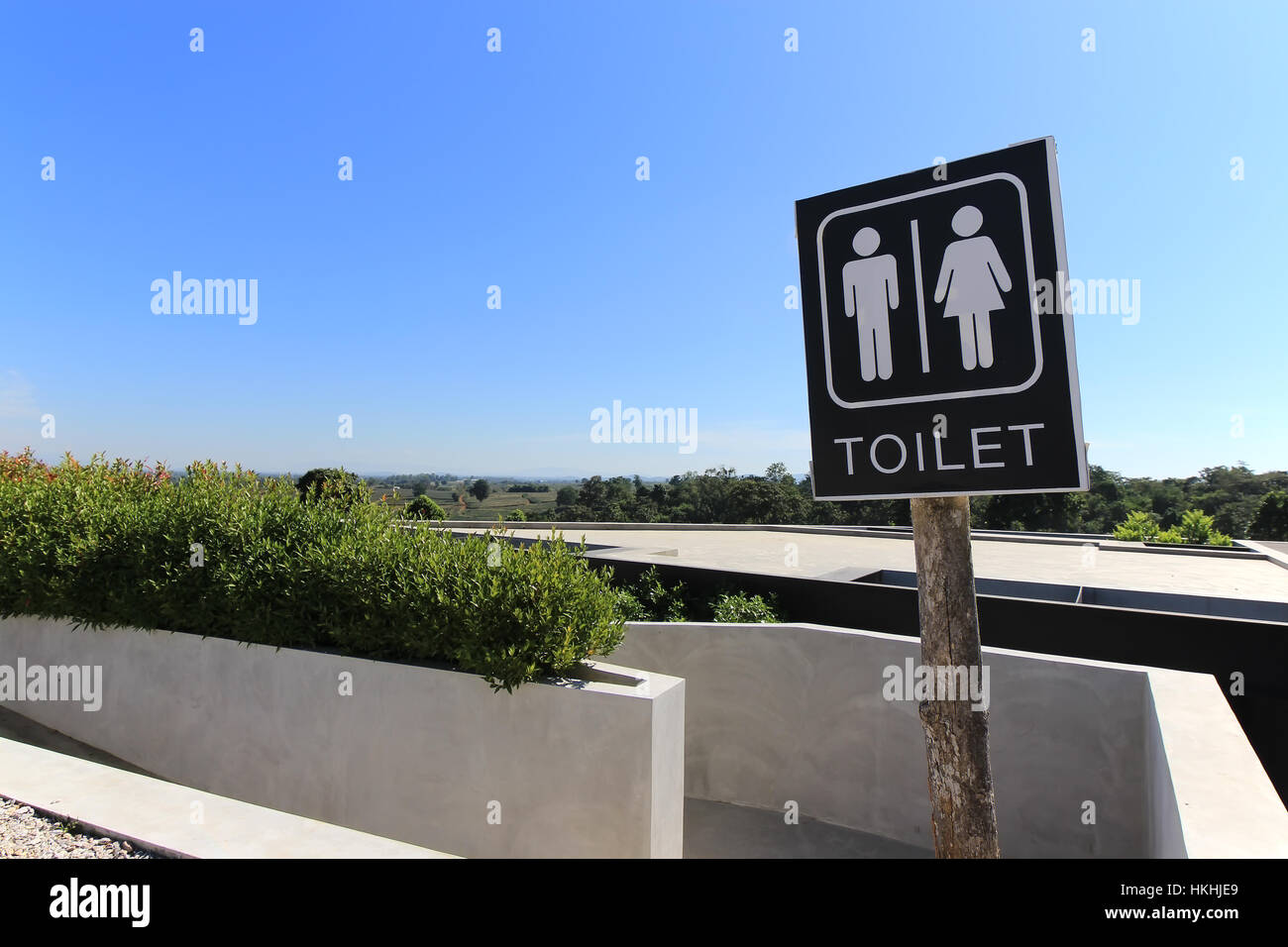Toilet sign and blue sky background Stock Photo - Alamy