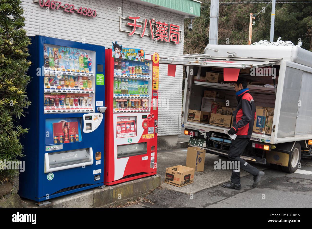 Delivery man replenishing vending machines with drinks from his van ...