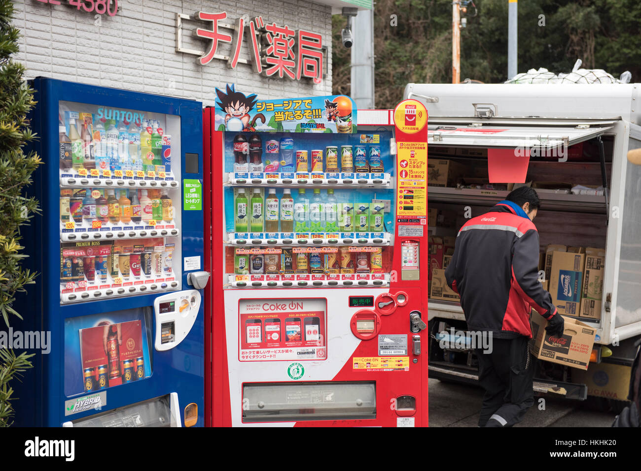 Delivery man replenishing vending machines with drinks from his van ...