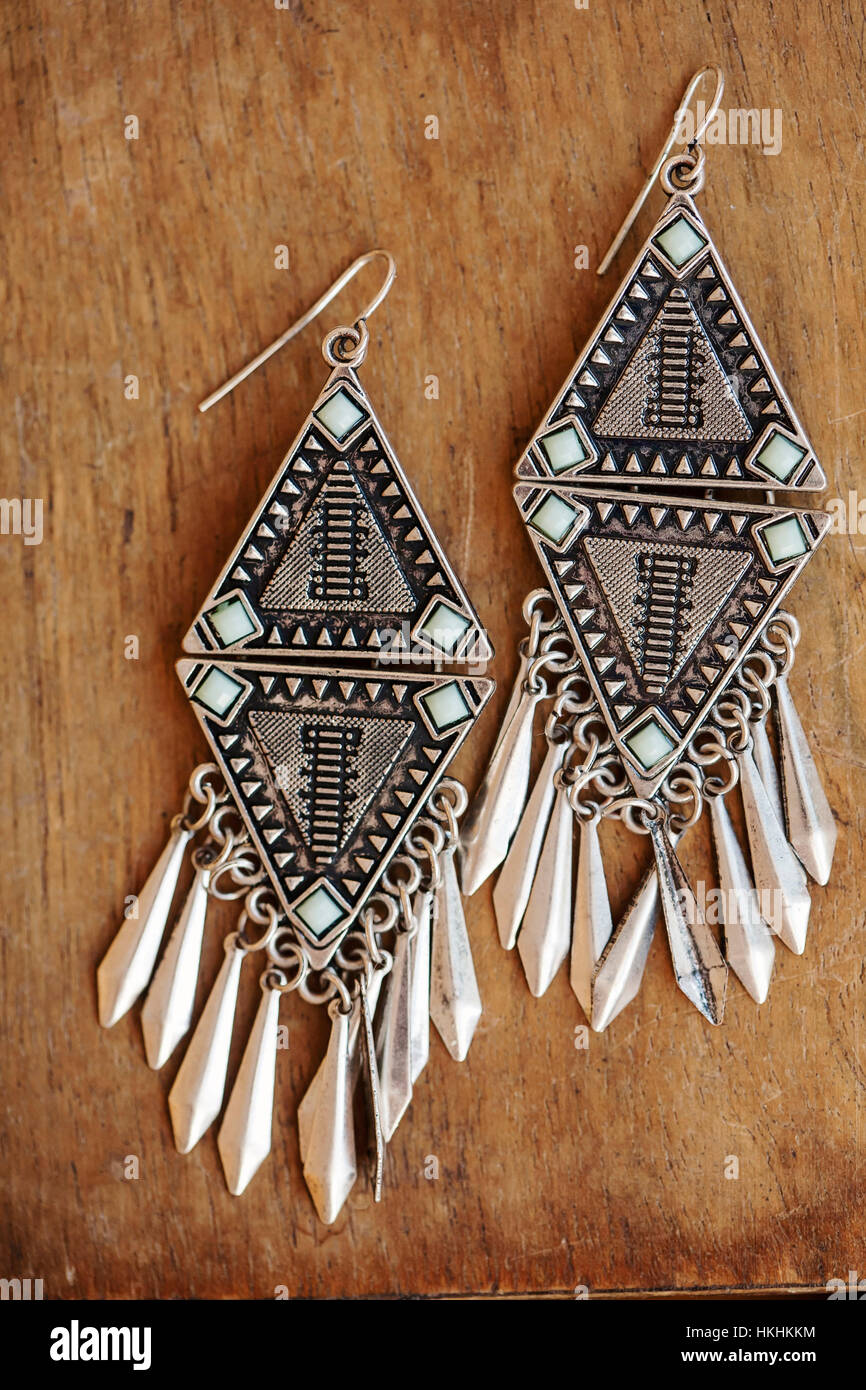 Beautiful Aztec earrings on wooden background Stock Photo - Alamy