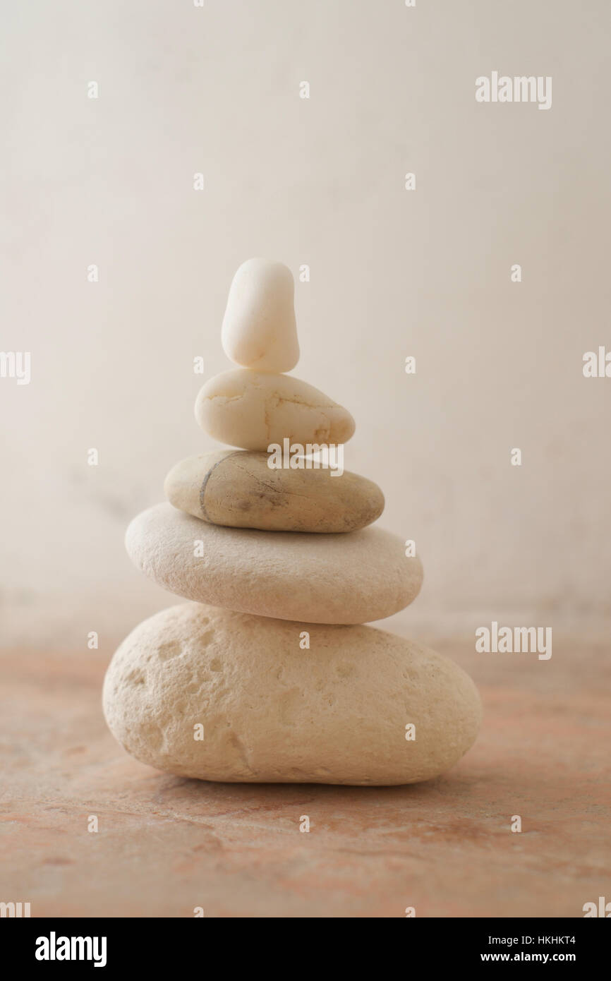 A stack of pebbles with light tones against a rustic background Stock ...