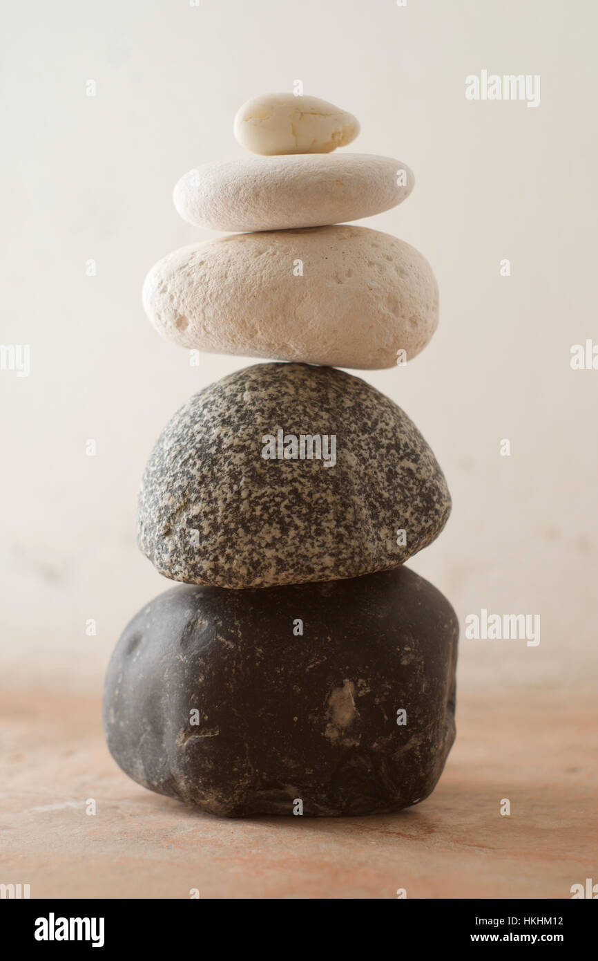 A stack of pebbles of various tones against a rustic background Stock ...