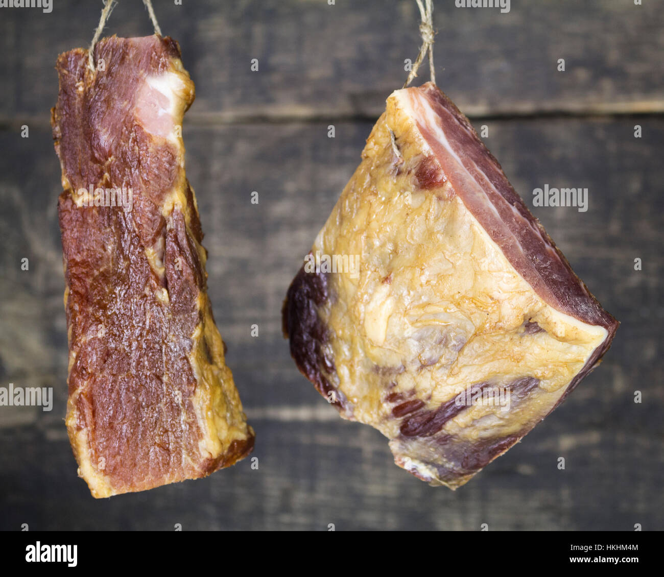 Smoked Pork Meat Hanging on the Rope Against Wooden Background Stock ...