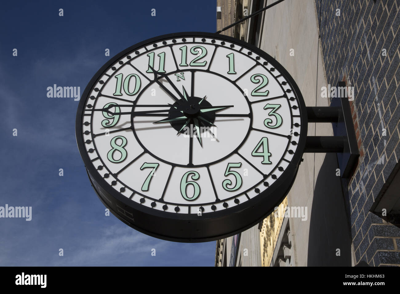 Clock on the outside of a building in the Chelsea neighborhood in NYC ...