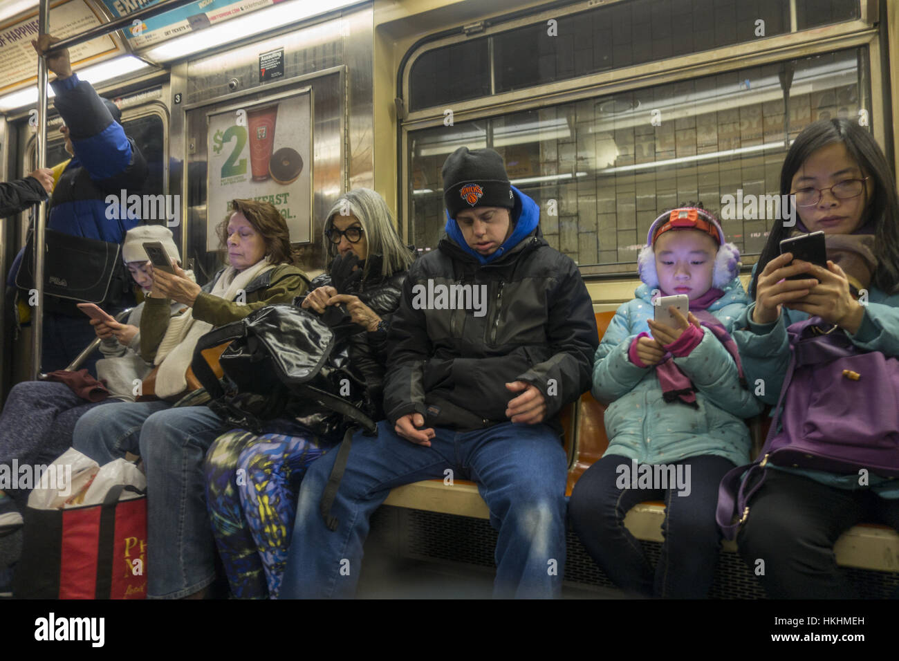 Many subway riders are glued to their phones as they ride trains around ...
