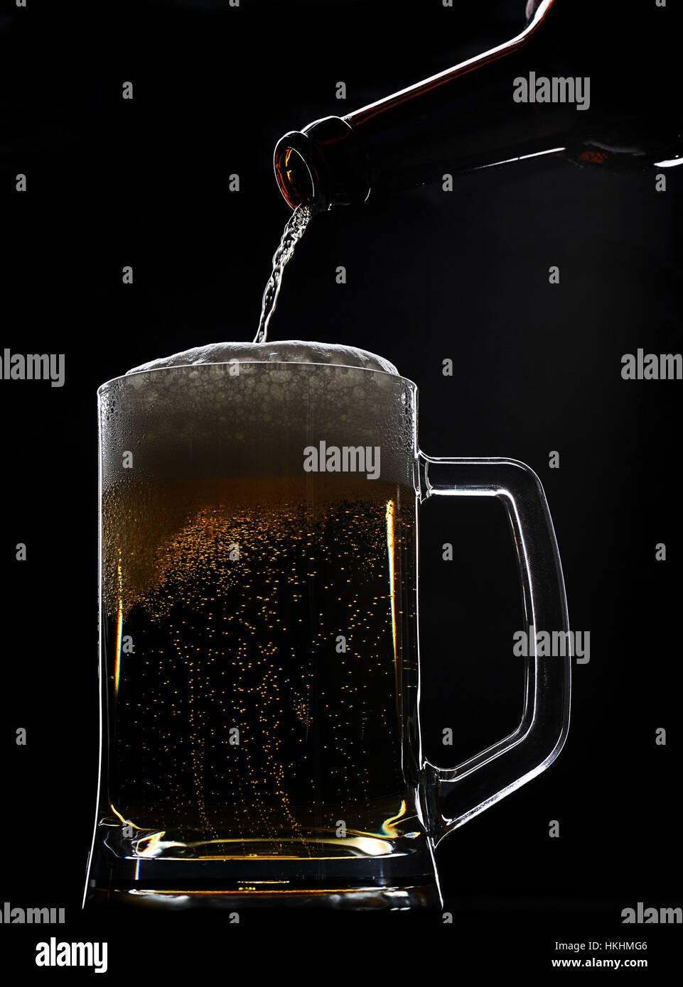 glass full beer and bottle on black background Stock Photo - Alamy