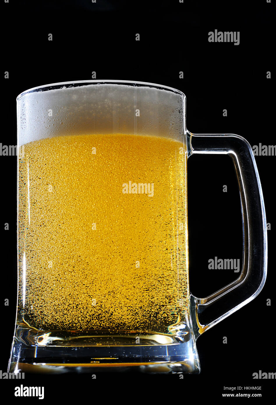 Sparkles in yellow beer glass on black background Stock Photo - Alamy