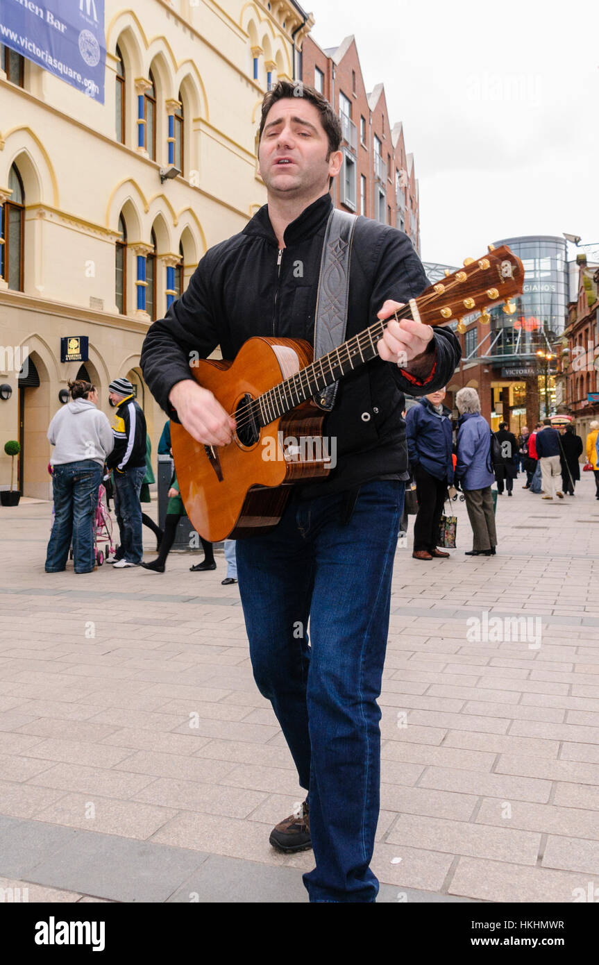 Brian Kennedy busks with a guitar in Belfast City Centre Stock Photo ...