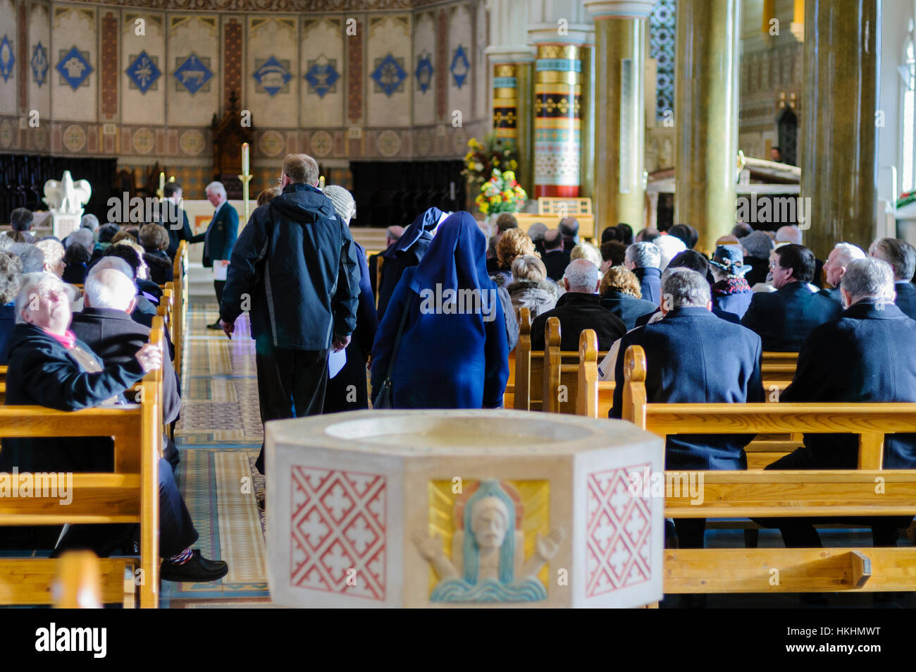 People, including two nuns, arrive at a church for a mass service Stock ...