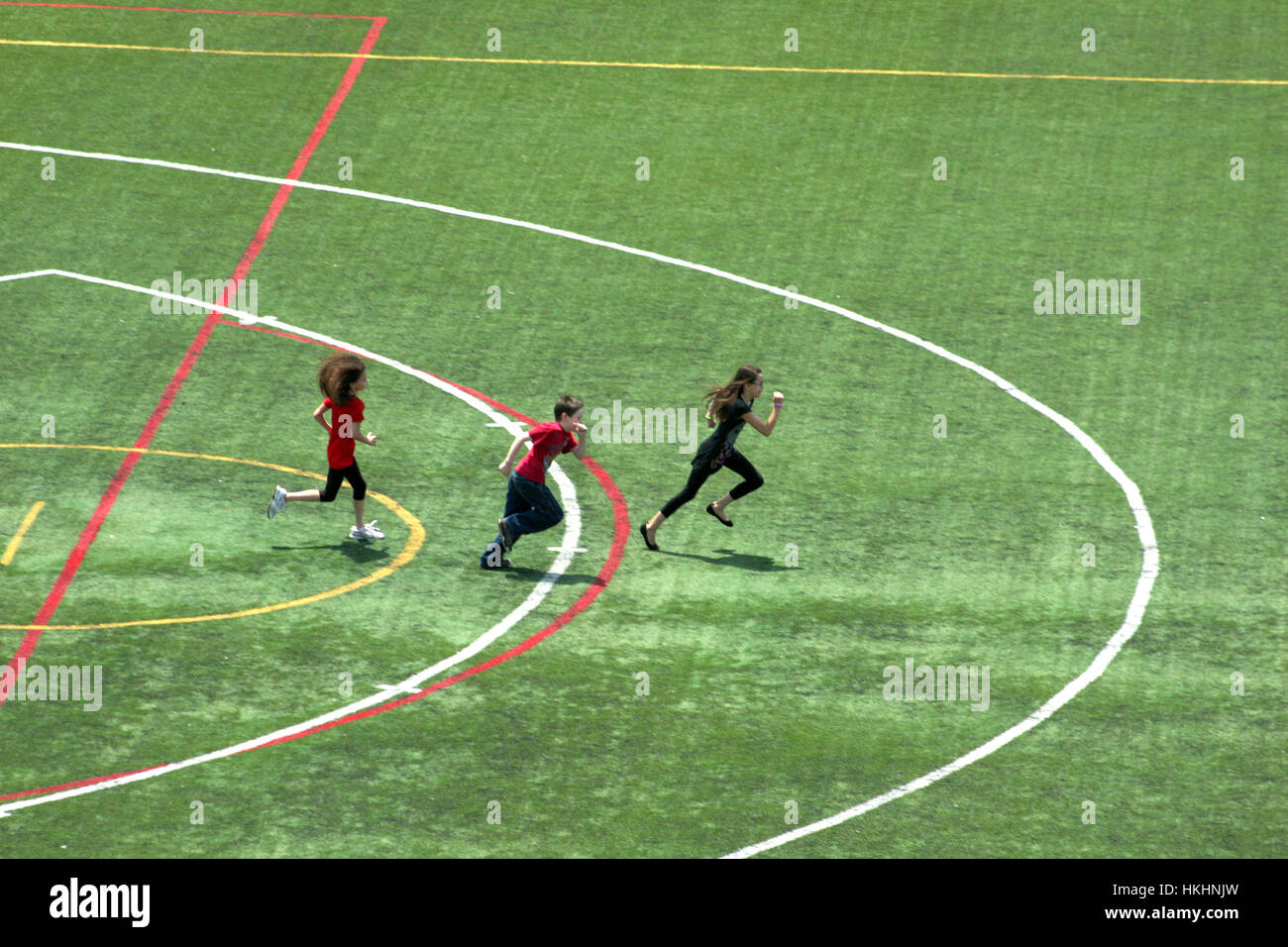 Children playing and running on athletic field Stock Photo - Alamy