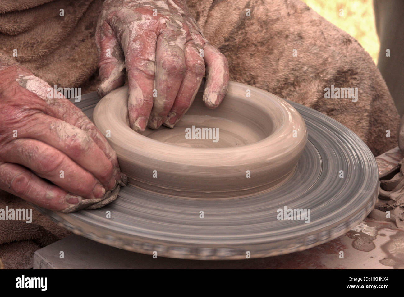 Close up on potter's hands shaping the clay on the wheel Stock Photo ...