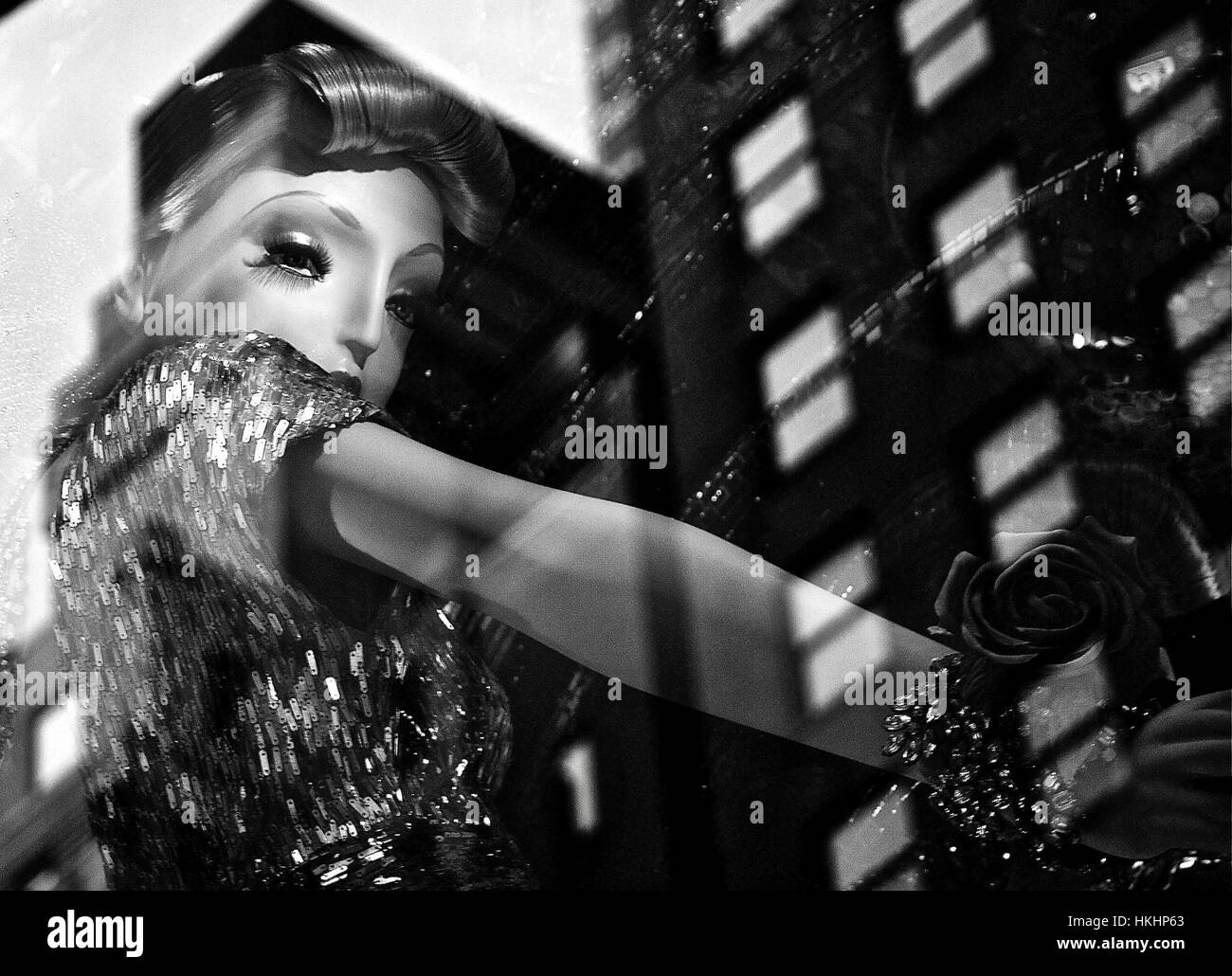 Black and white image of a 50's style mannequin with window reflection ...