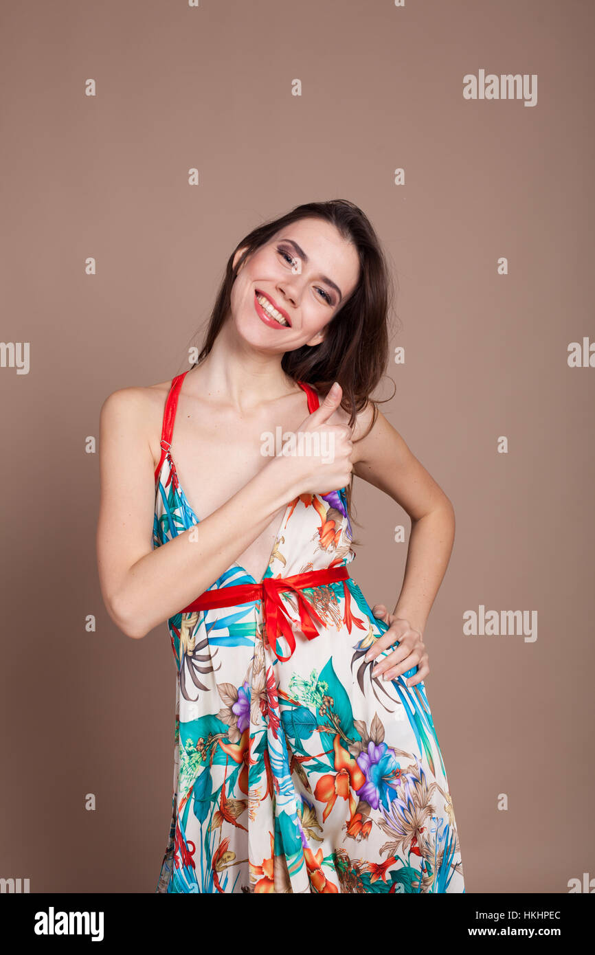 girl in colored dress shows fingers Stock Photo - Alamy