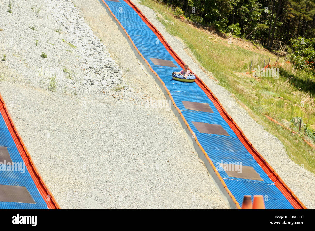 Children sliding downhill on long tubing run Stock Photo - Alamy