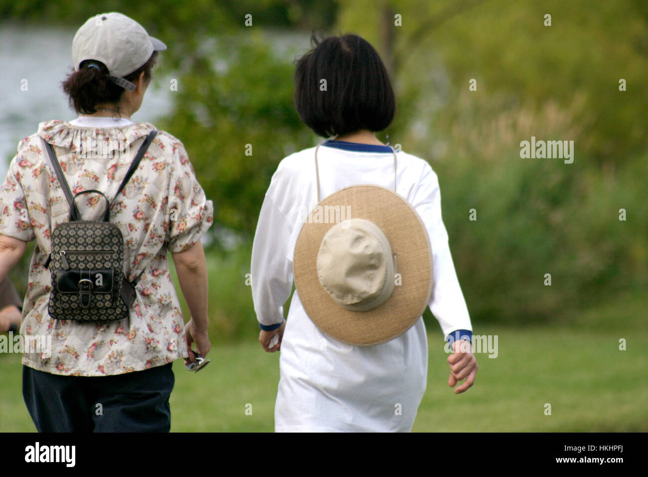 Two middle-aged women walking on park trail Stock Photo - Alamy