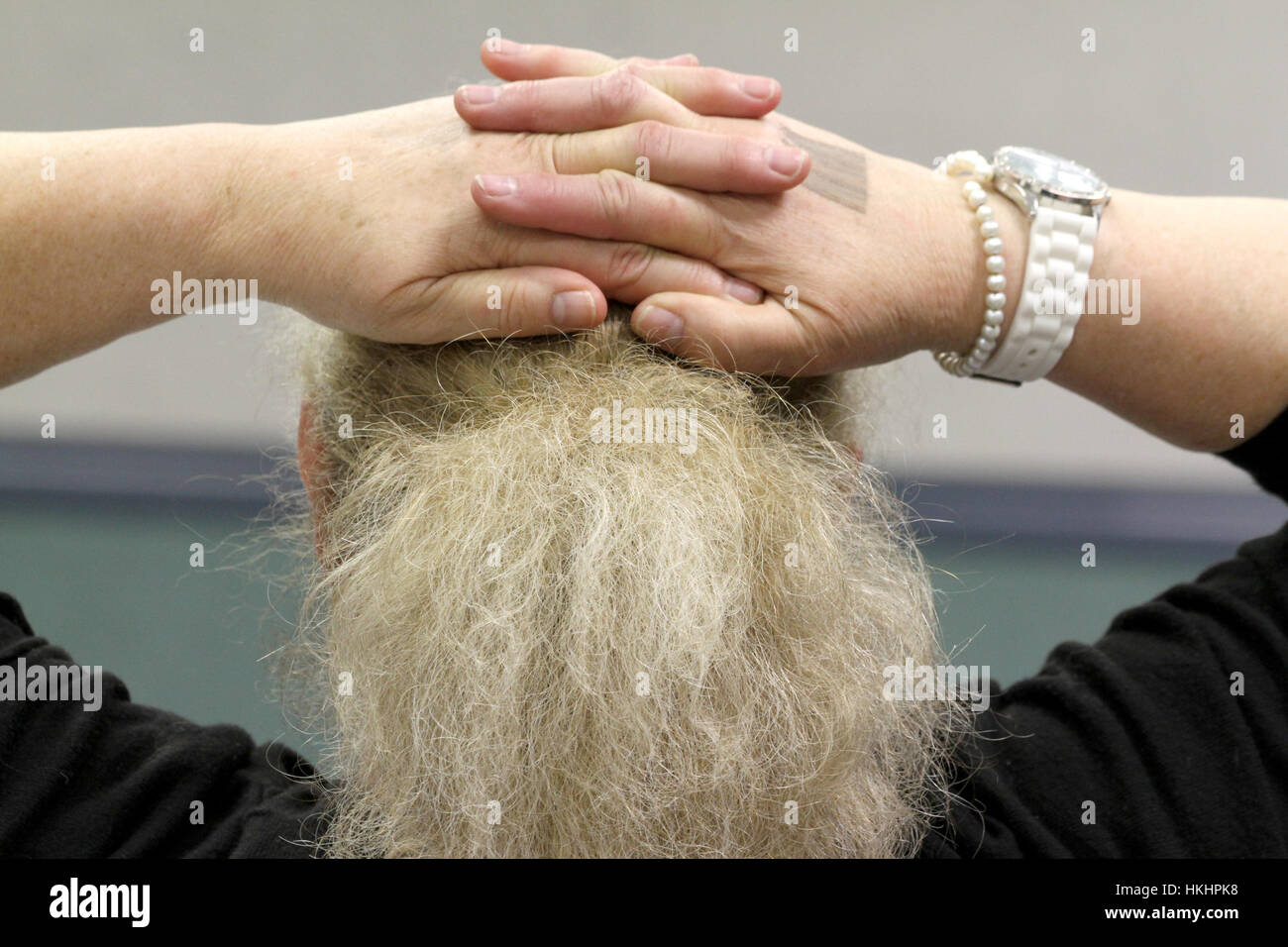 Back of woman with hands on her hand, in a tense posture Stock Photo ...