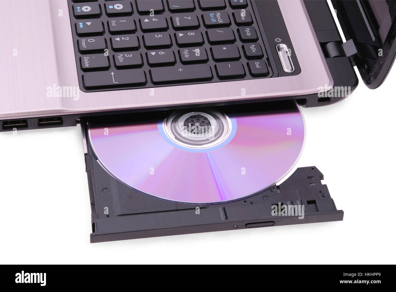 Laptop on white background. DVD disc in the drive. Clipping path ...