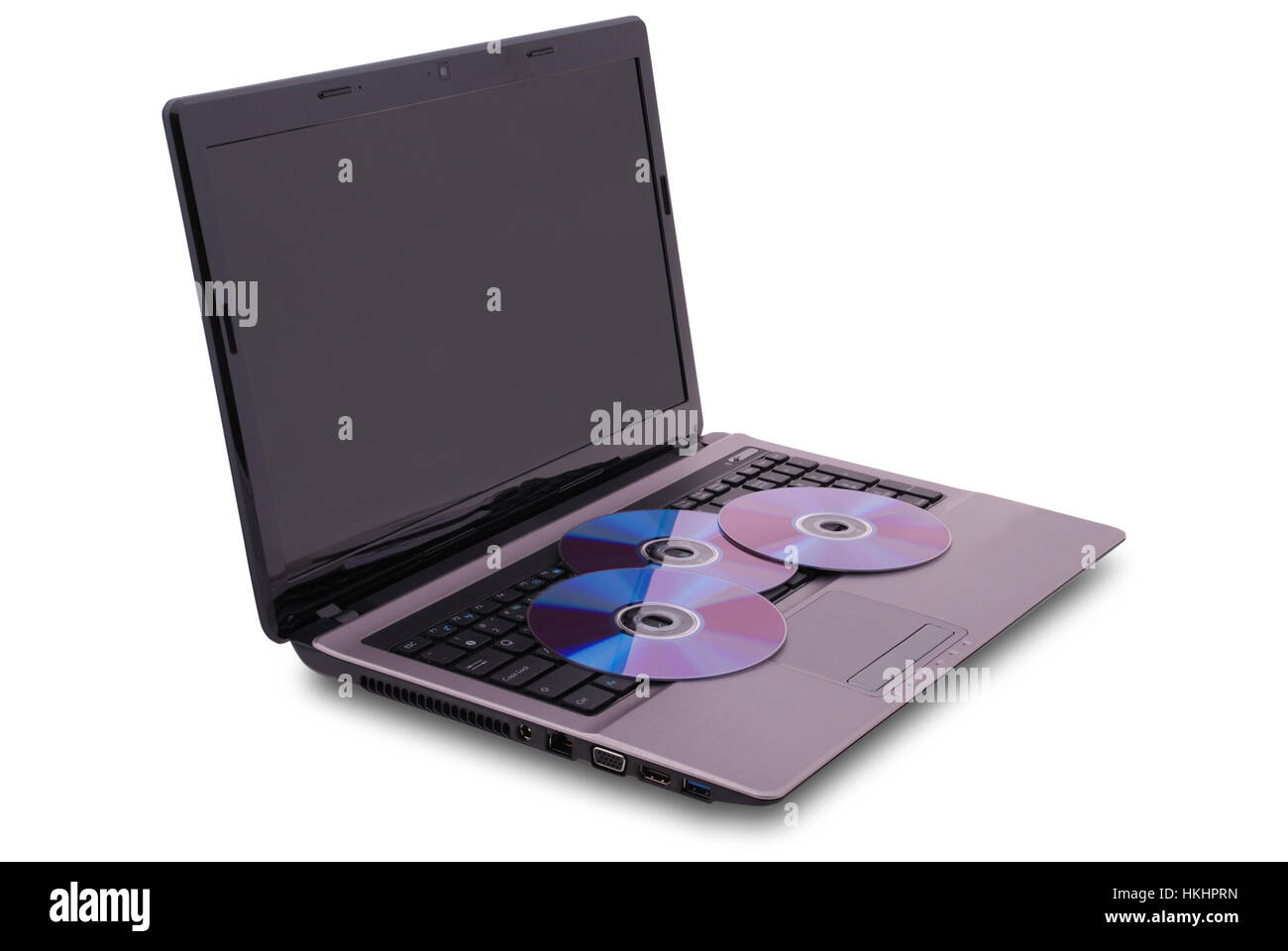 Laptop on white background. Three CD are on the keyboard. Clipping path ...