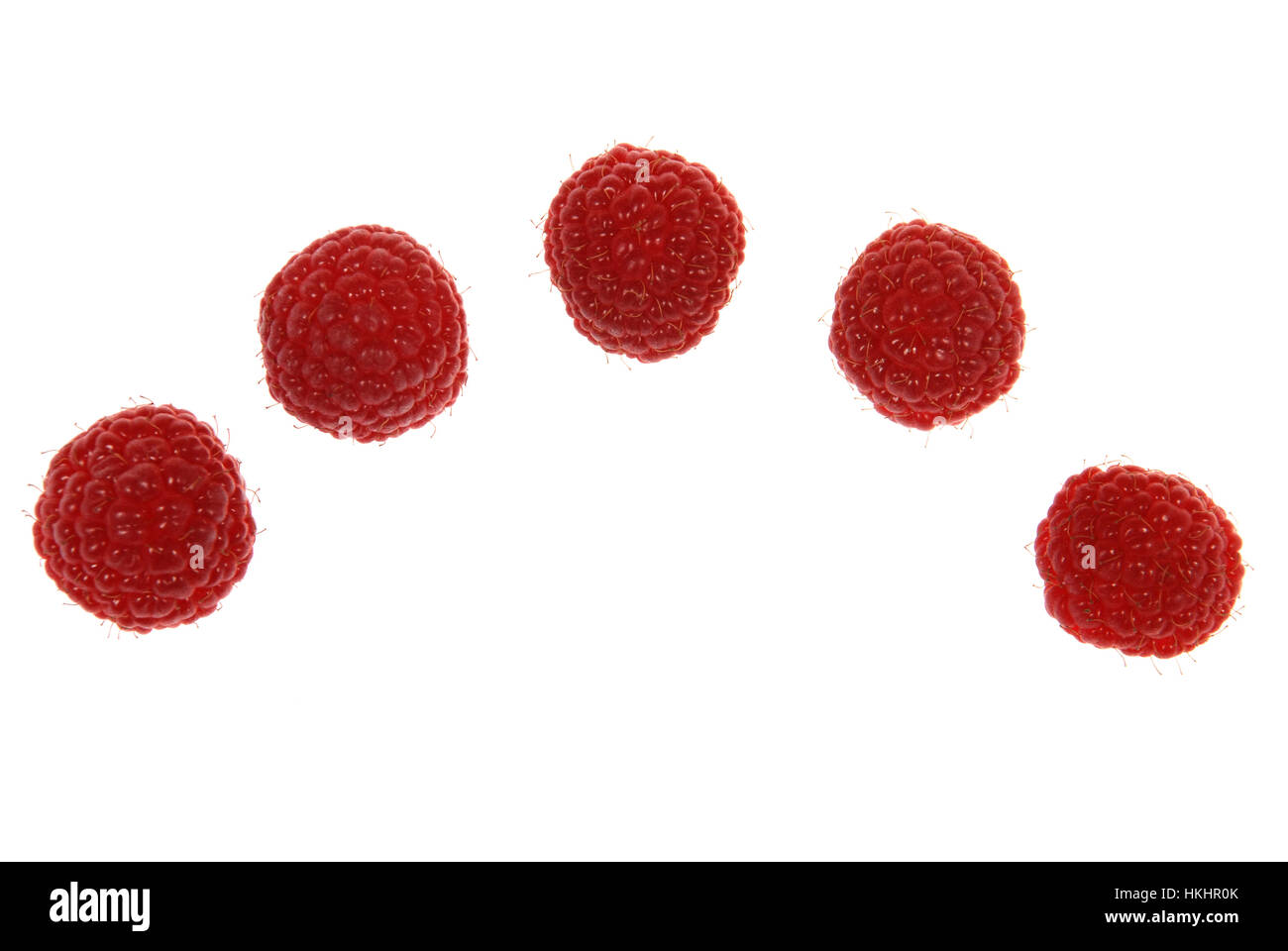Raspberries in row isolated on white background Stock Photo - Alamy