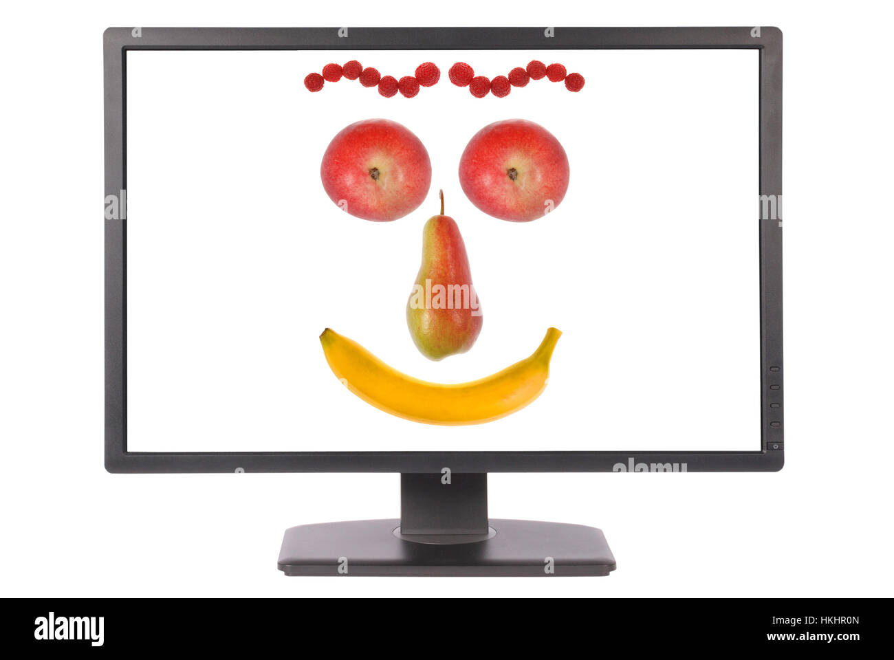 Computer monitor on white background. Funny face made from fruit on ...