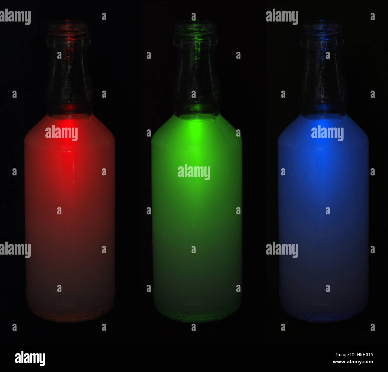 Three rgb bottle with a color drink on a black background Stock Photo ...