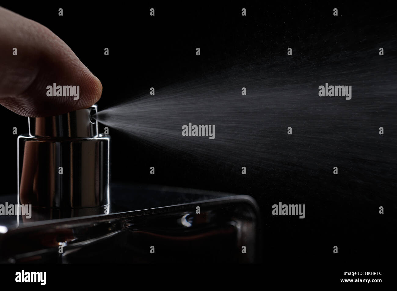 nozzle spray perfume on black close up Stock Photo - Alamy