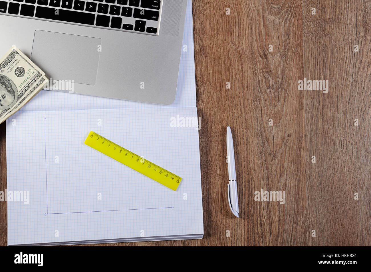 notebook with graph schedule diagram dollars money laptop on wood table ...