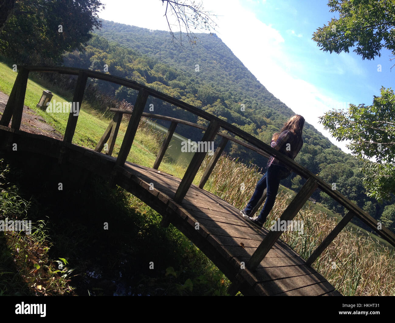 young girl walking on bridge Stock Photo - Alamy