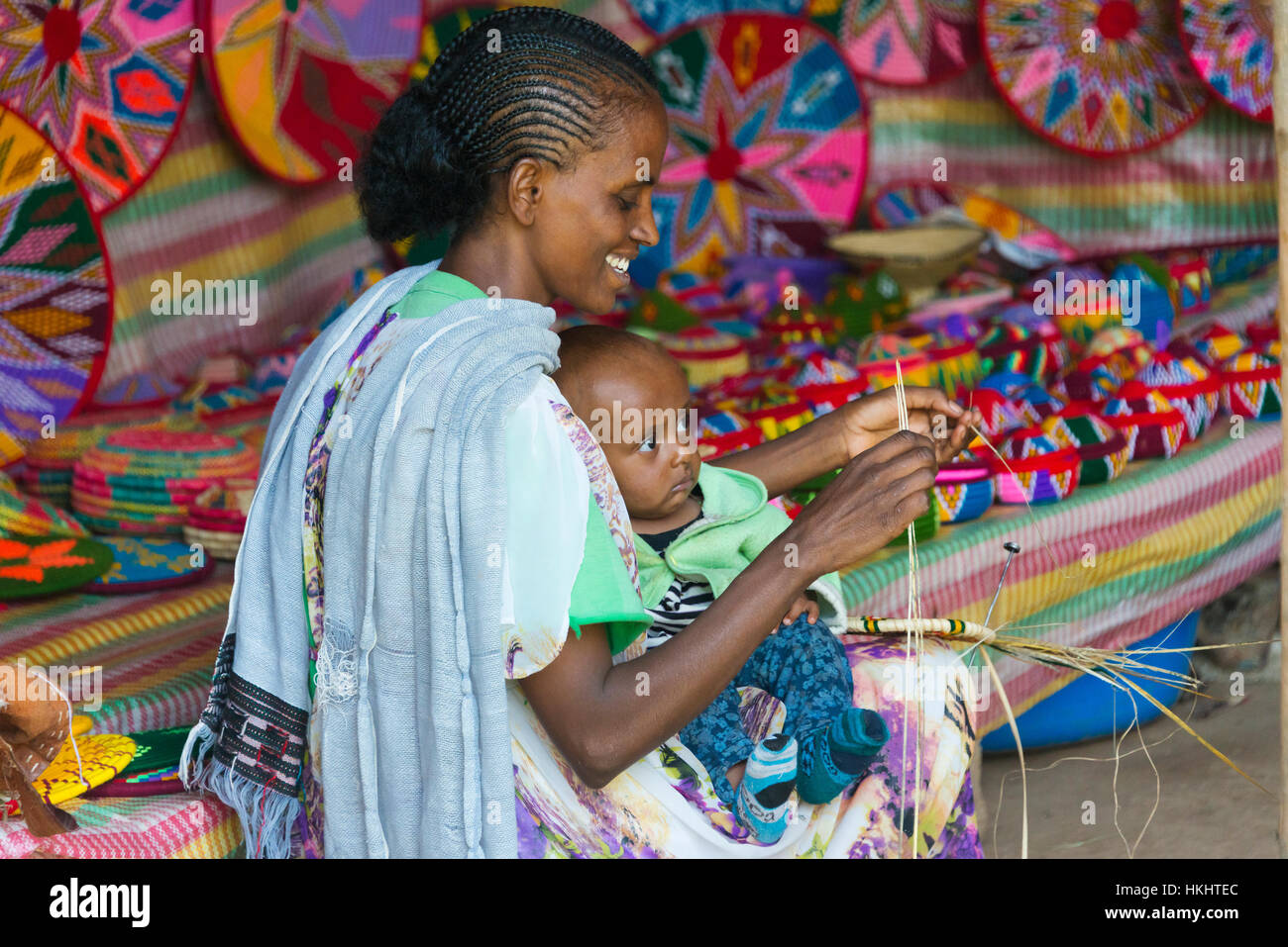 Woman carrying child weaving basket, Aksum, Ethiopia Stock Photo - Alamy