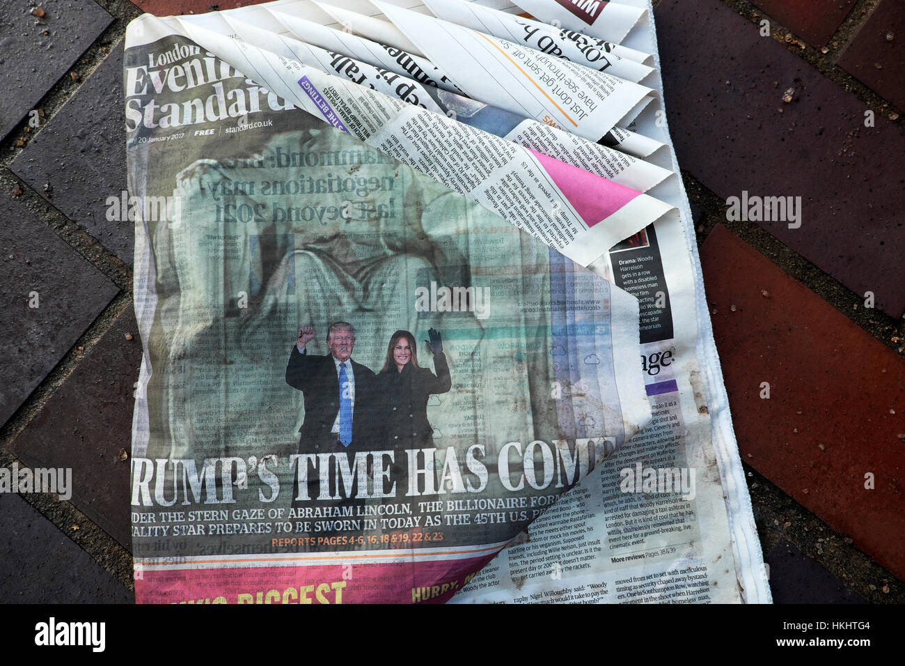 An old wet Sunday newspaper lies on the pavement in London after Donald ...