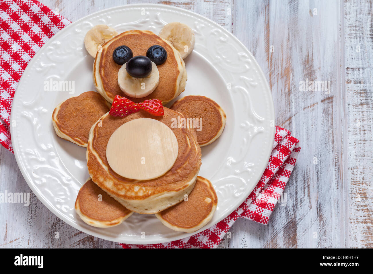 Funny bear pancakes with berries for kids breakfast Stock Photo - Alamy