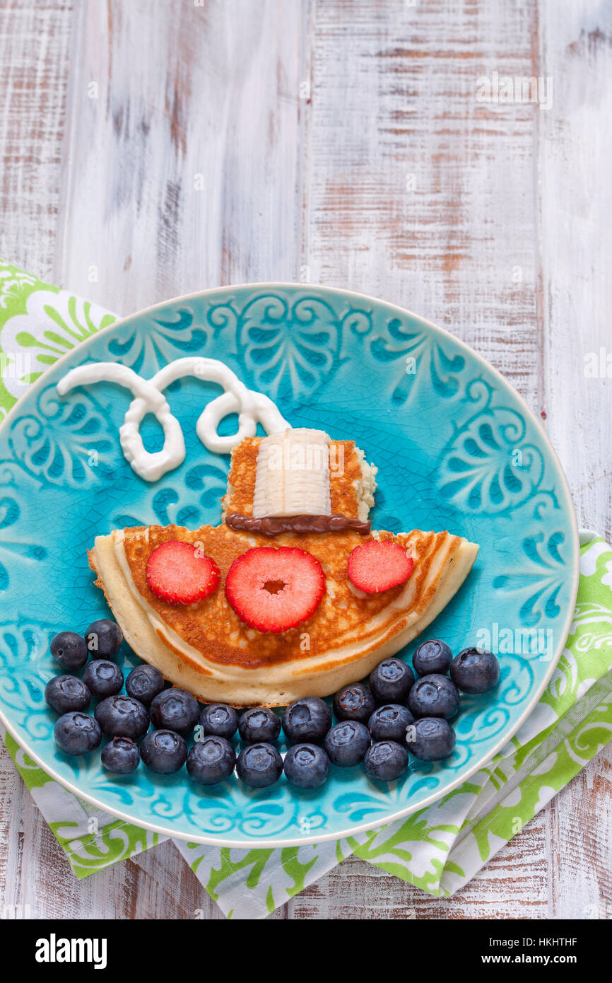 Ship boat pancake with berries for kids breakfast Stock Photo - Alamy