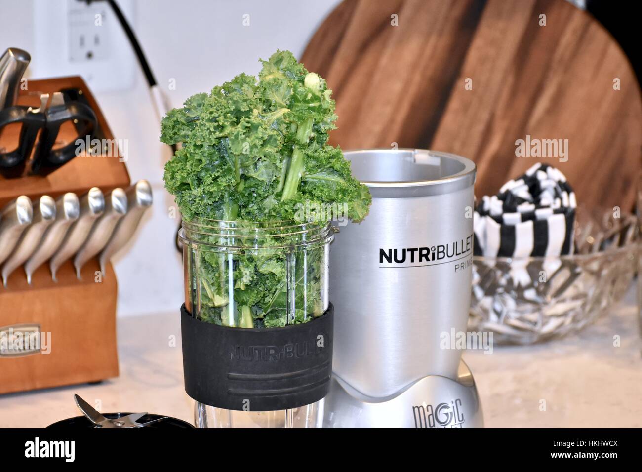 Kale stuffed and over filling a blender Stock Photo - Alamy