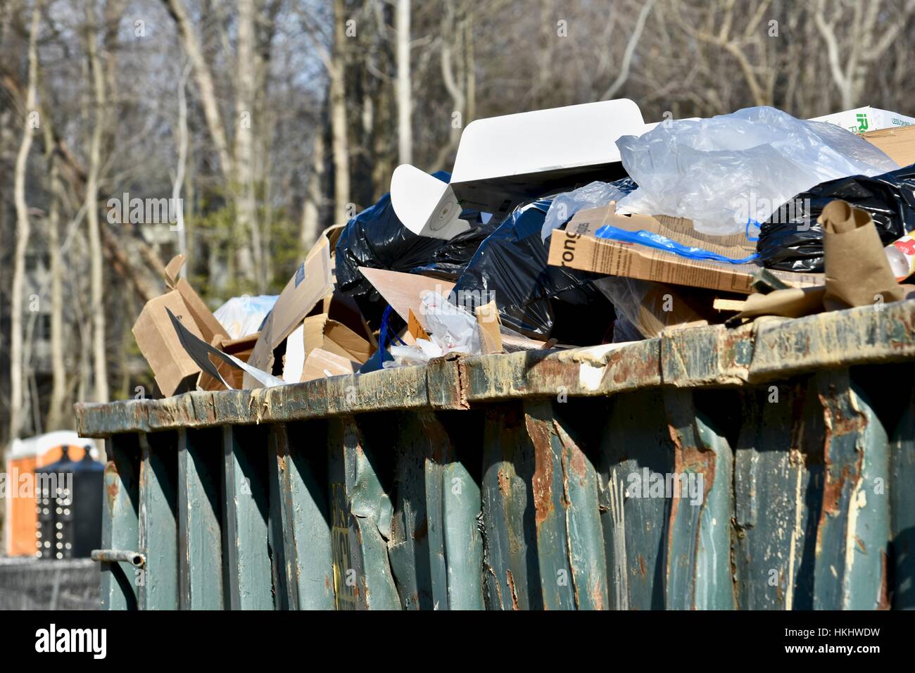 A construction dumpster completely filled over the top Stock Photo - Alamy