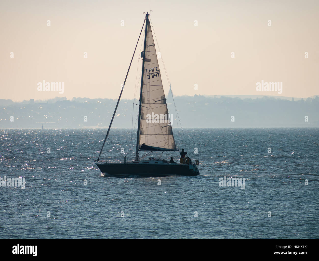 A sailing boat at sunset in the Solent, England Stock Photo - Alamy