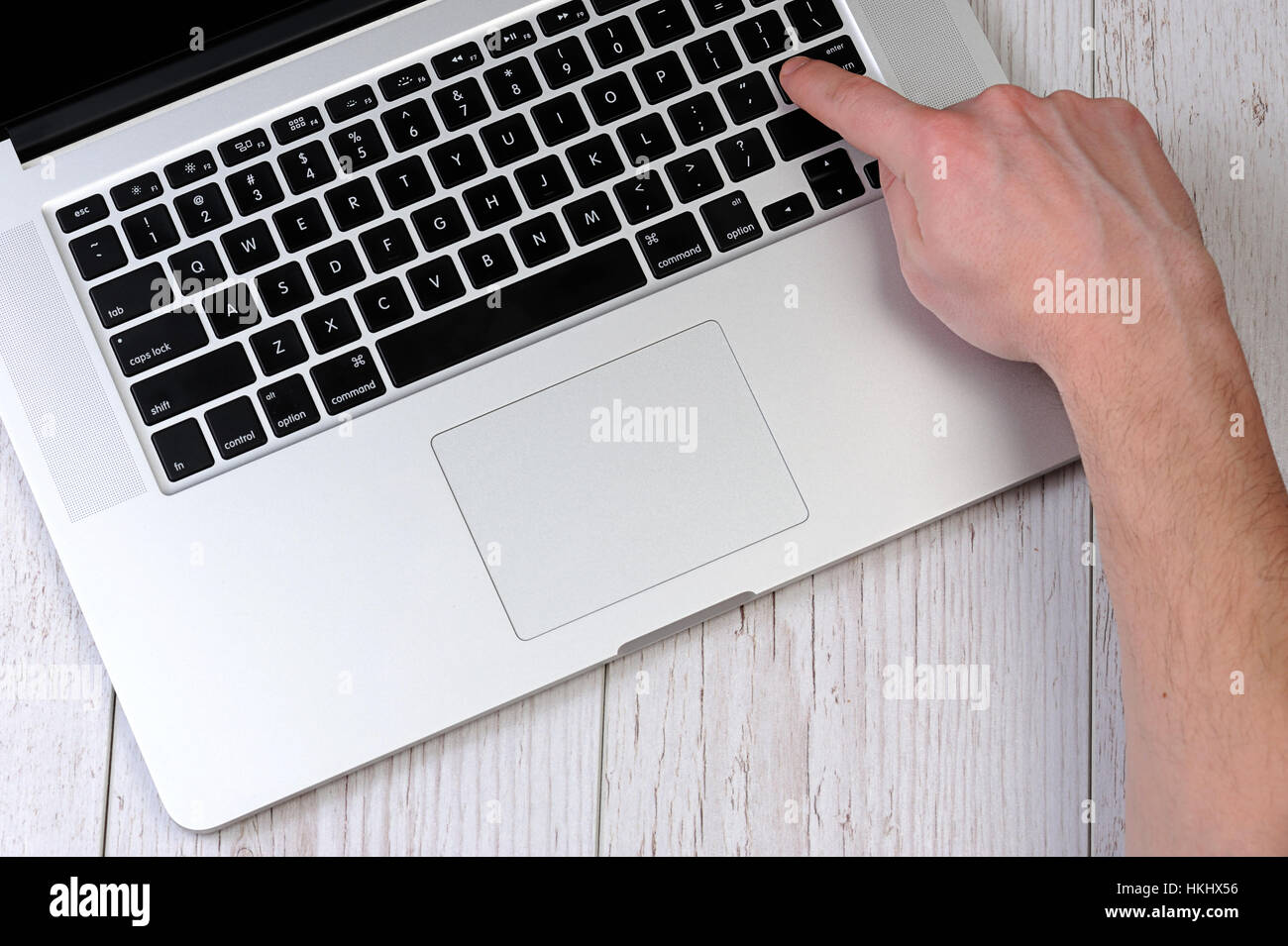 press enter button on laptop on wood table Stock Photo - Alamy