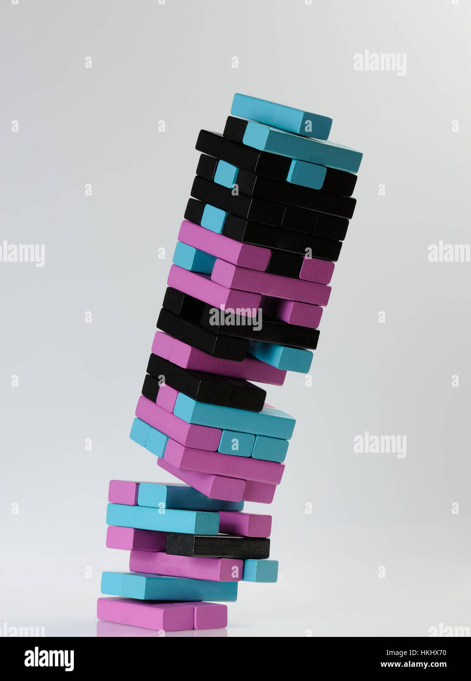 falling color jenga tower on white background Stock Photo - Alamy