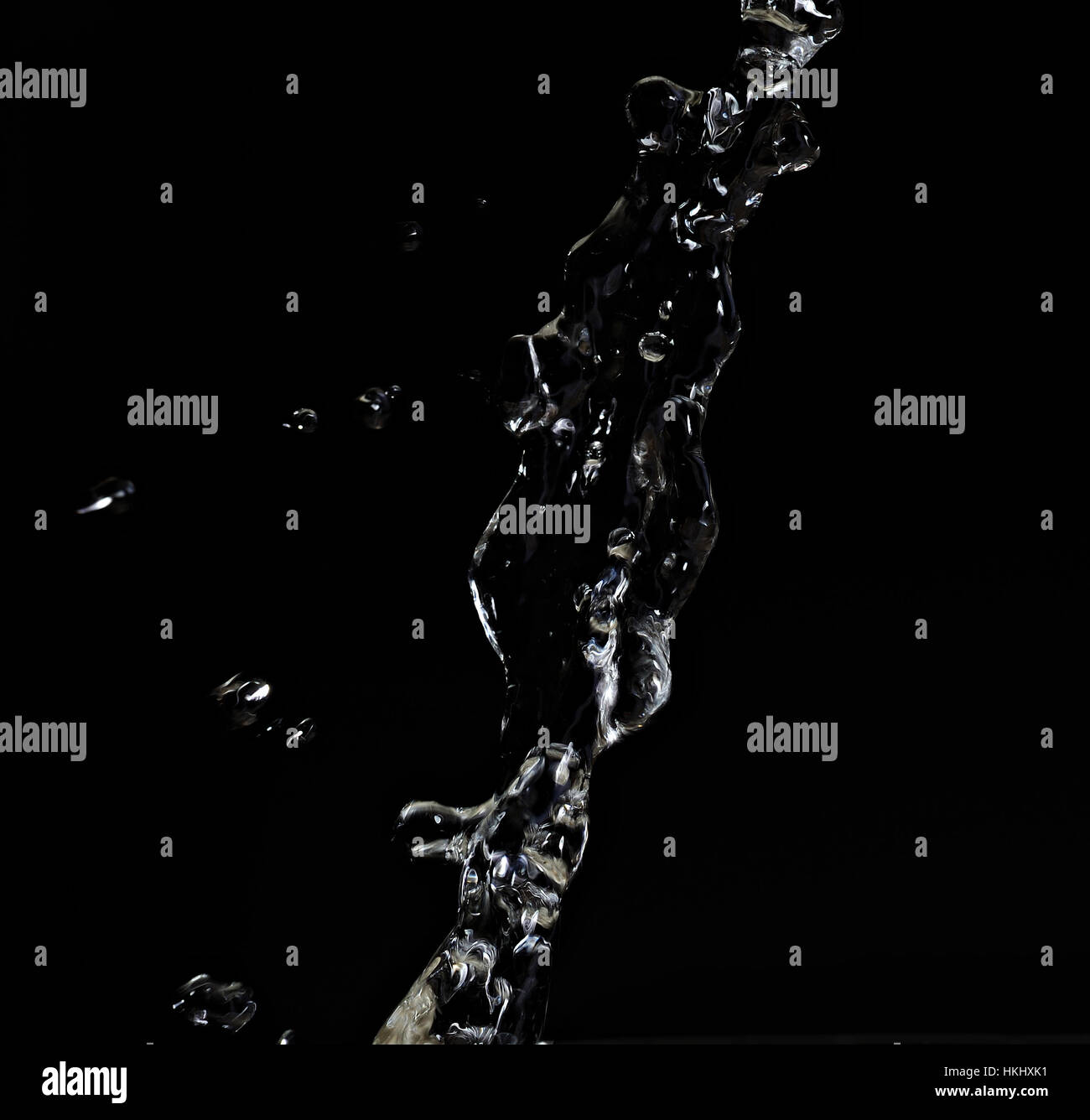 Macro of pouring splash water isolated on black Stock Photo - Alamy