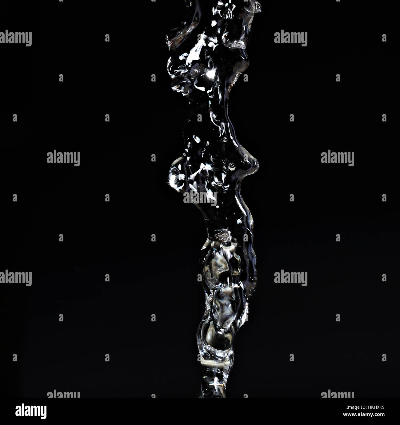 pouring water long splash isolated black background Stock Photo - Alamy