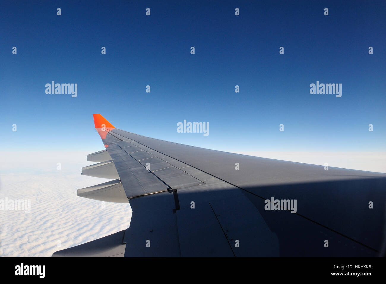 wide plane wing in blue sky from window Stock Photo - Alamy