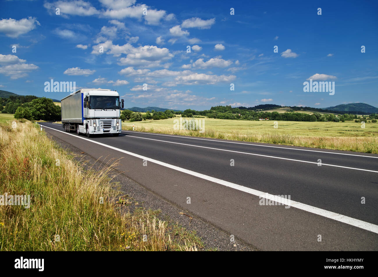 Rural landscape with road you are driving a white truck, in the ...