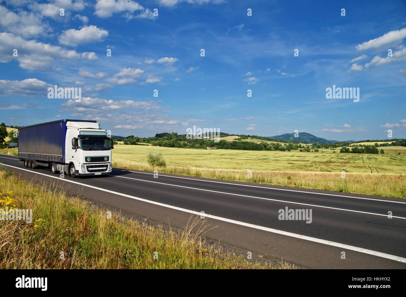 Rural landscape with road you are driving a white truck, in the ...