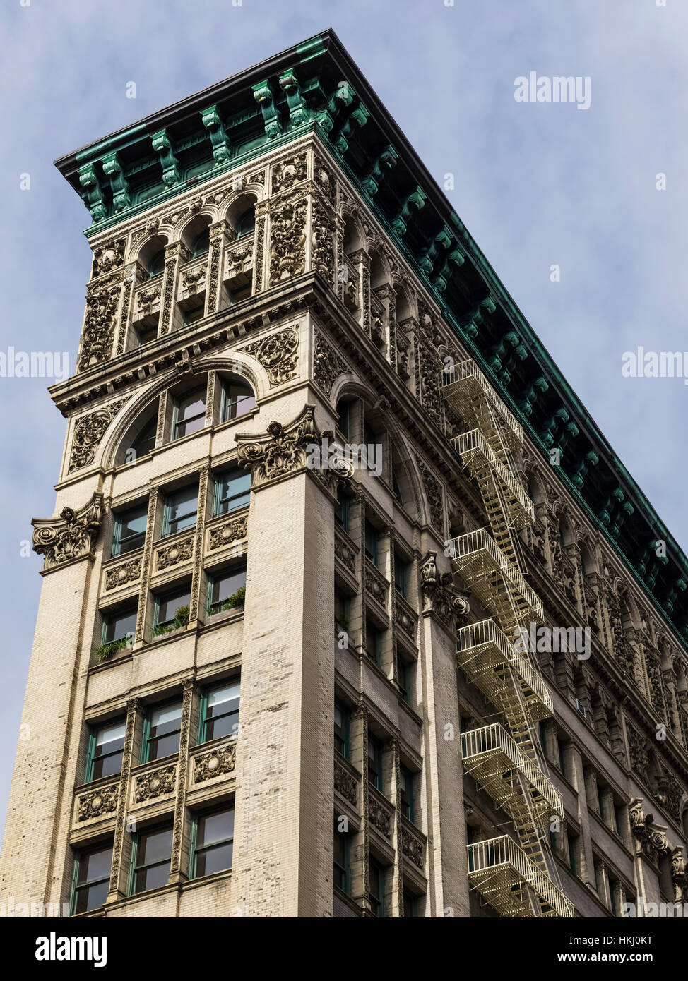 Residential building with ornate facade and fire escapes in lower ...