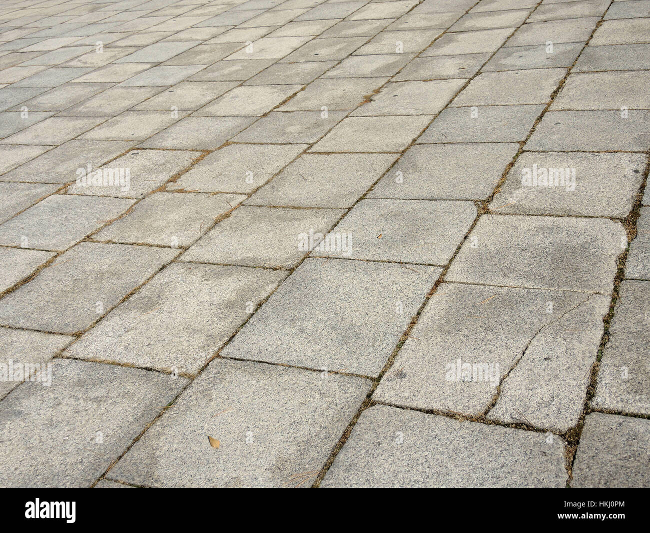 Patterned paving stone. Granite cobble stoned pavement background Stock ...