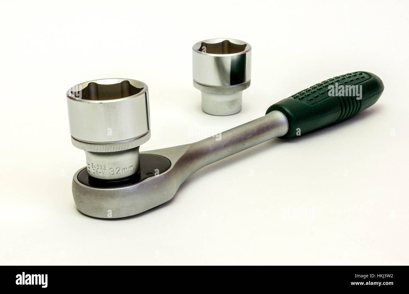 On a white background is a ratchet-wrench and two union heads on bolts ...